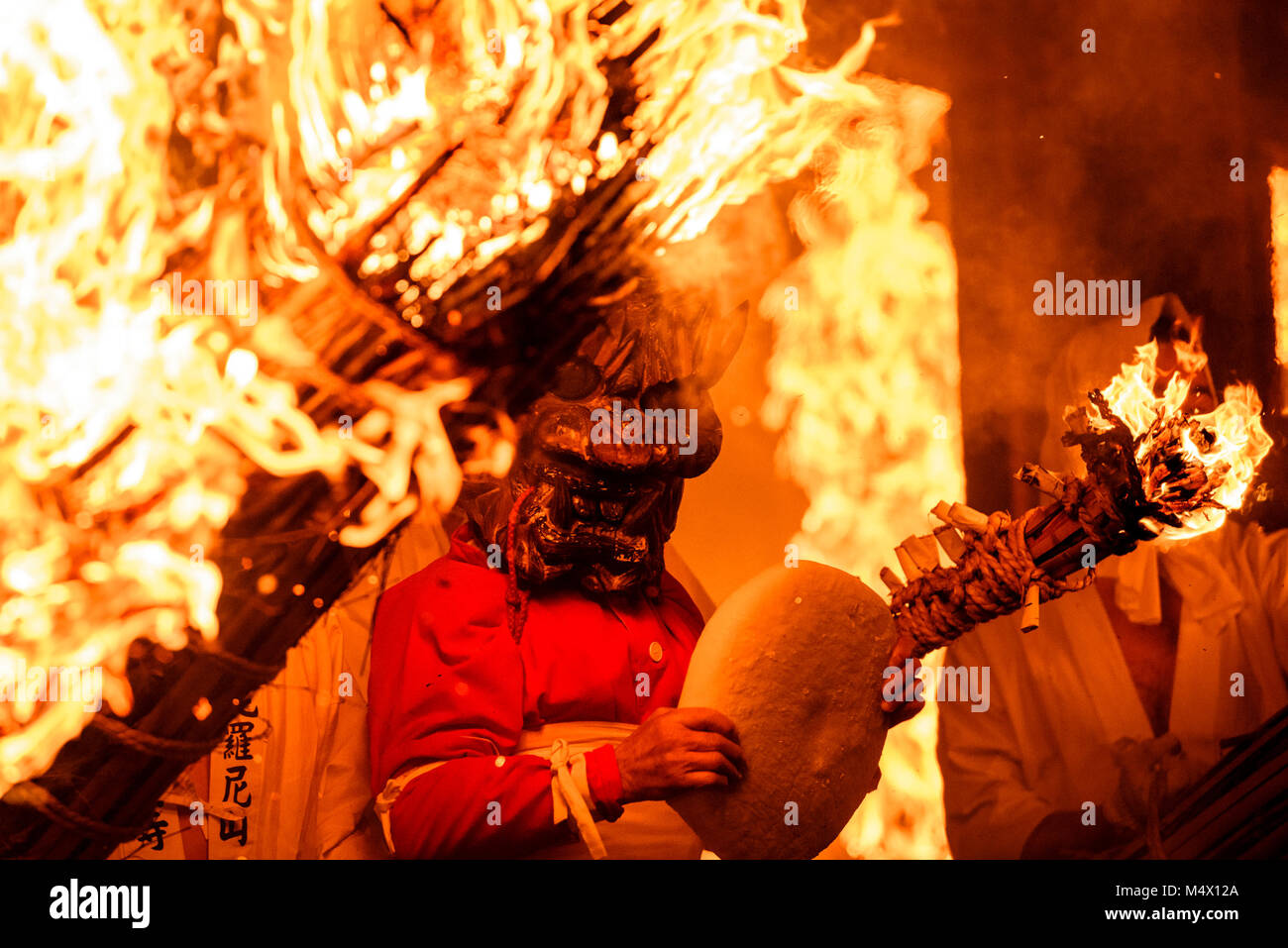 FEBRUARY 17, 2018 - A man wears an ogre mask during a fire ceremony at ...