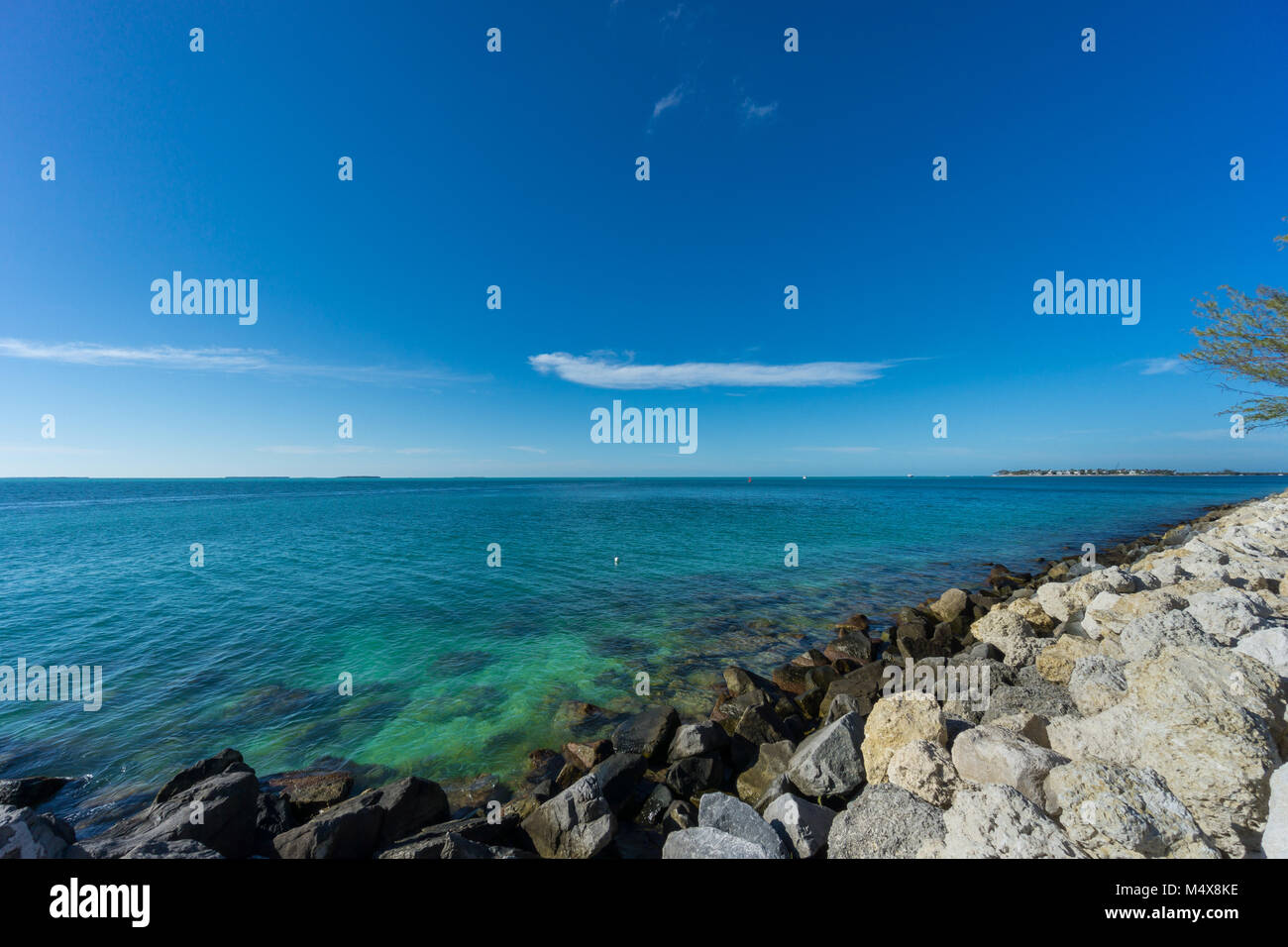 USA, Florida, Blue clean clear ocean water at key west behind white ...