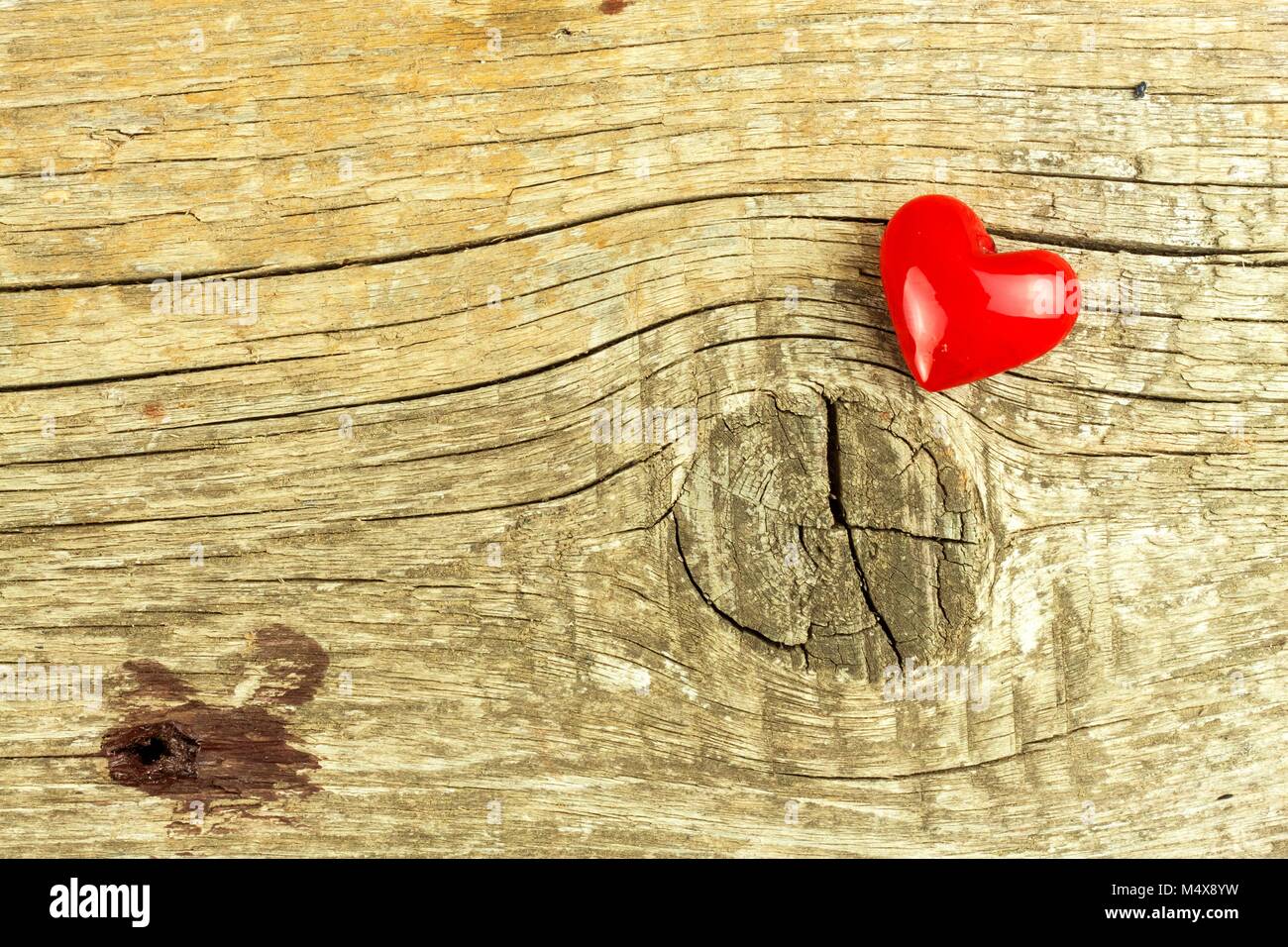 Red heart on a wooden background. The symbol of love. The memory of ...