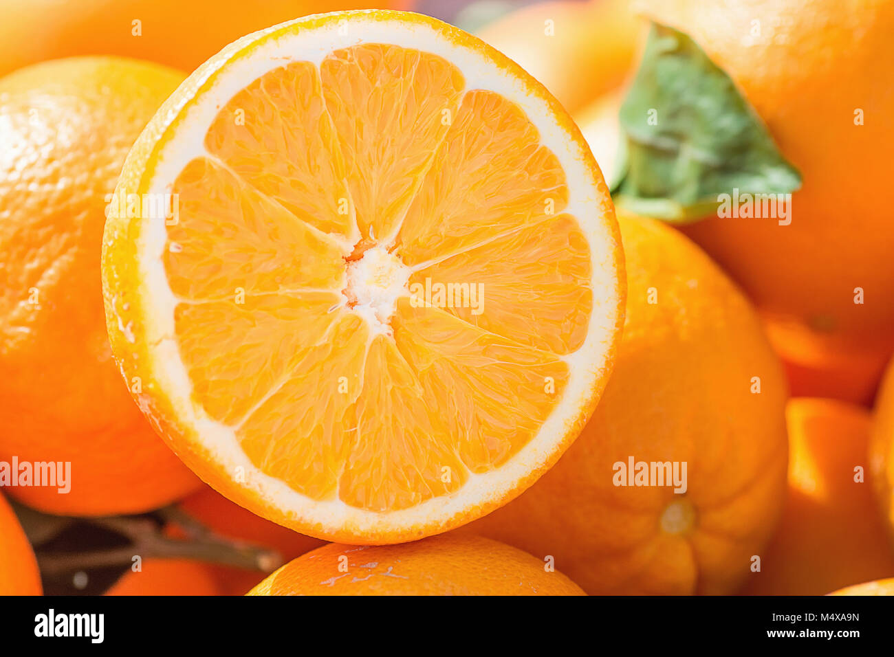 Heap of Ripe Organic Oranges at Farmers Market. One Fruit Cut in Half ...
