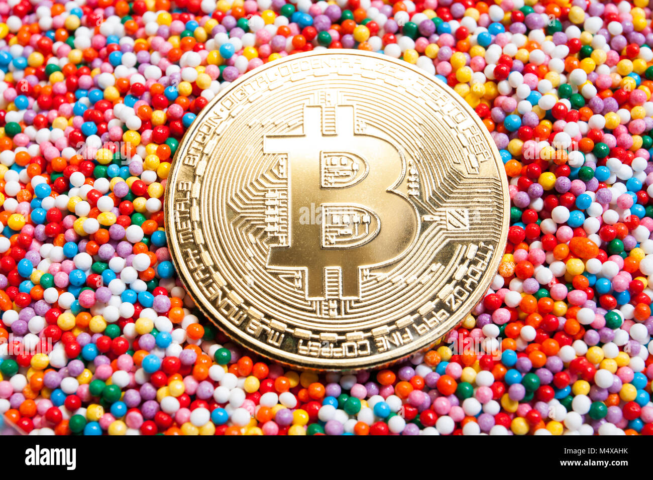 Golden Bitcoin coin on a colorful candy background close up Stock Photo ...