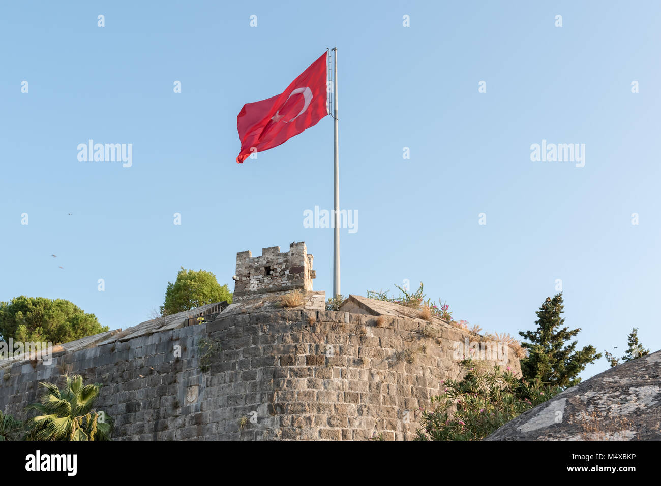 Exterior view of Castle of St. Peter (Bodrum Castle) and Turkish flag ...