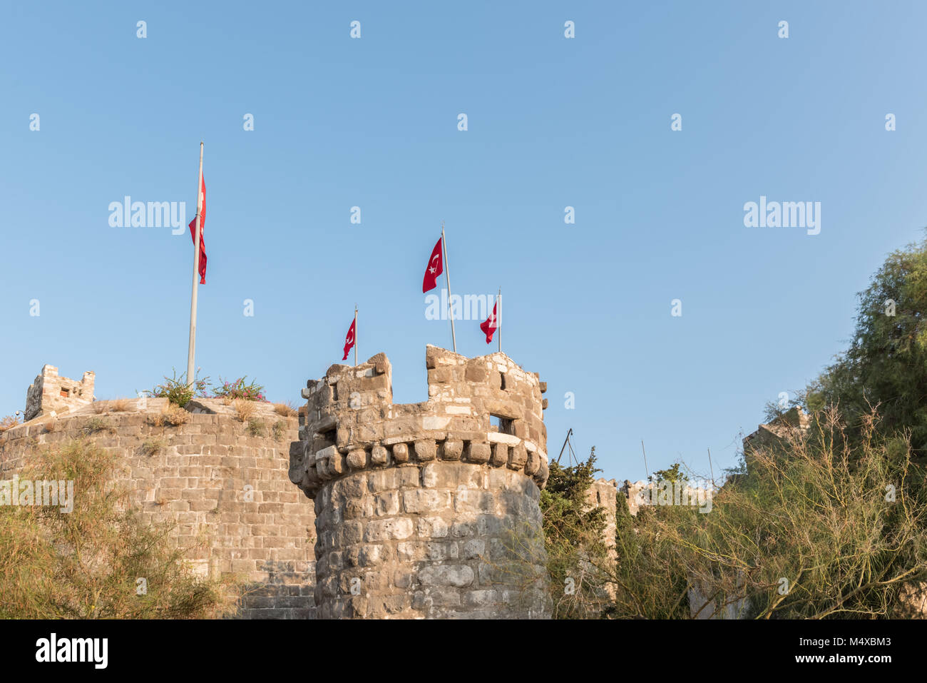 Exterior view of Castle of St. Peter (Bodrum Castle) and Turkish flag ...