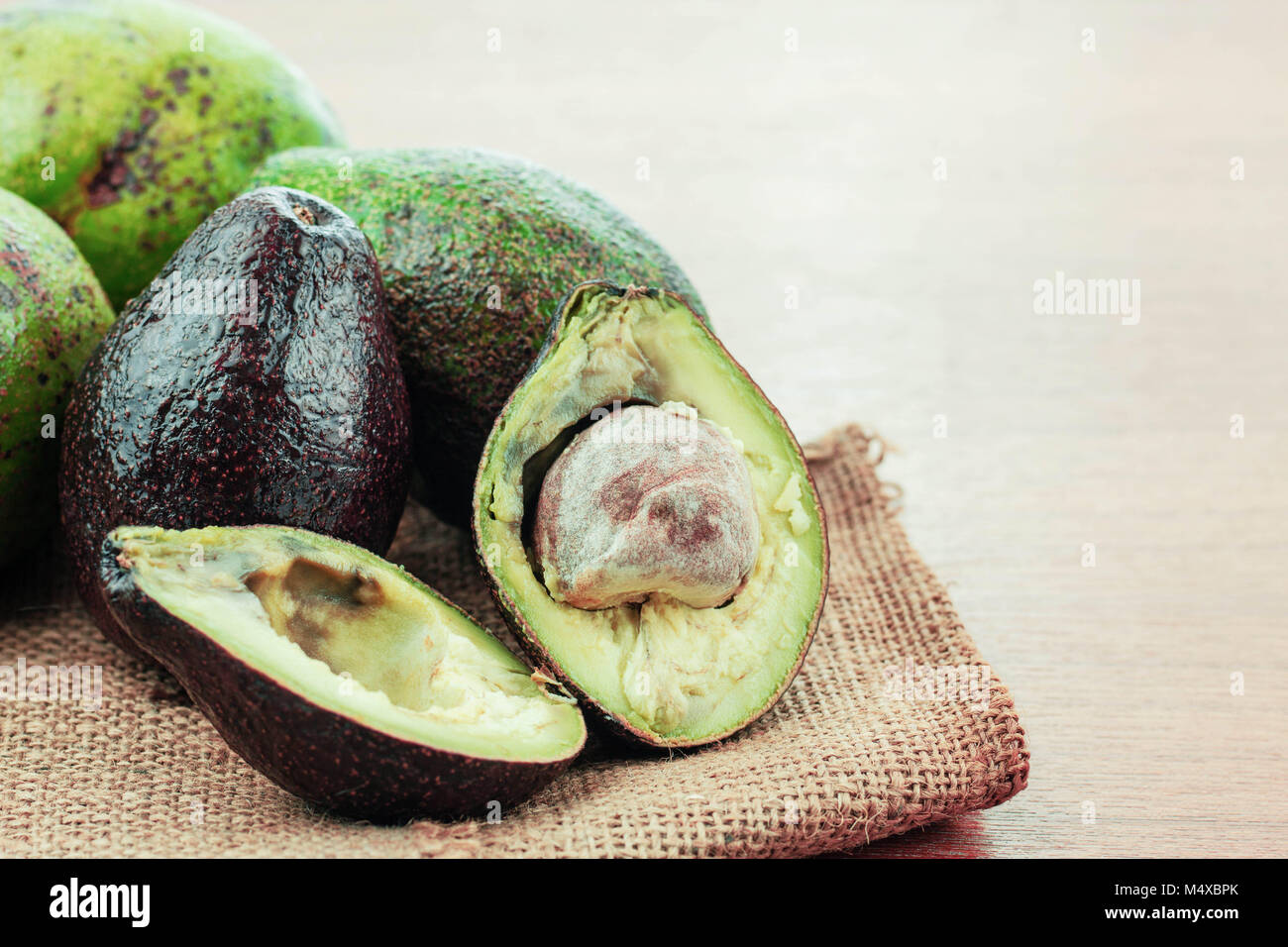 Ripe fruit of avocado on sack Stock Photo - Alamy