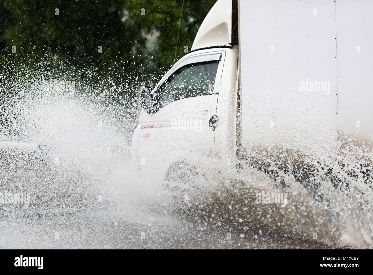car rain puddle splashing water Stock Photo - Alamy