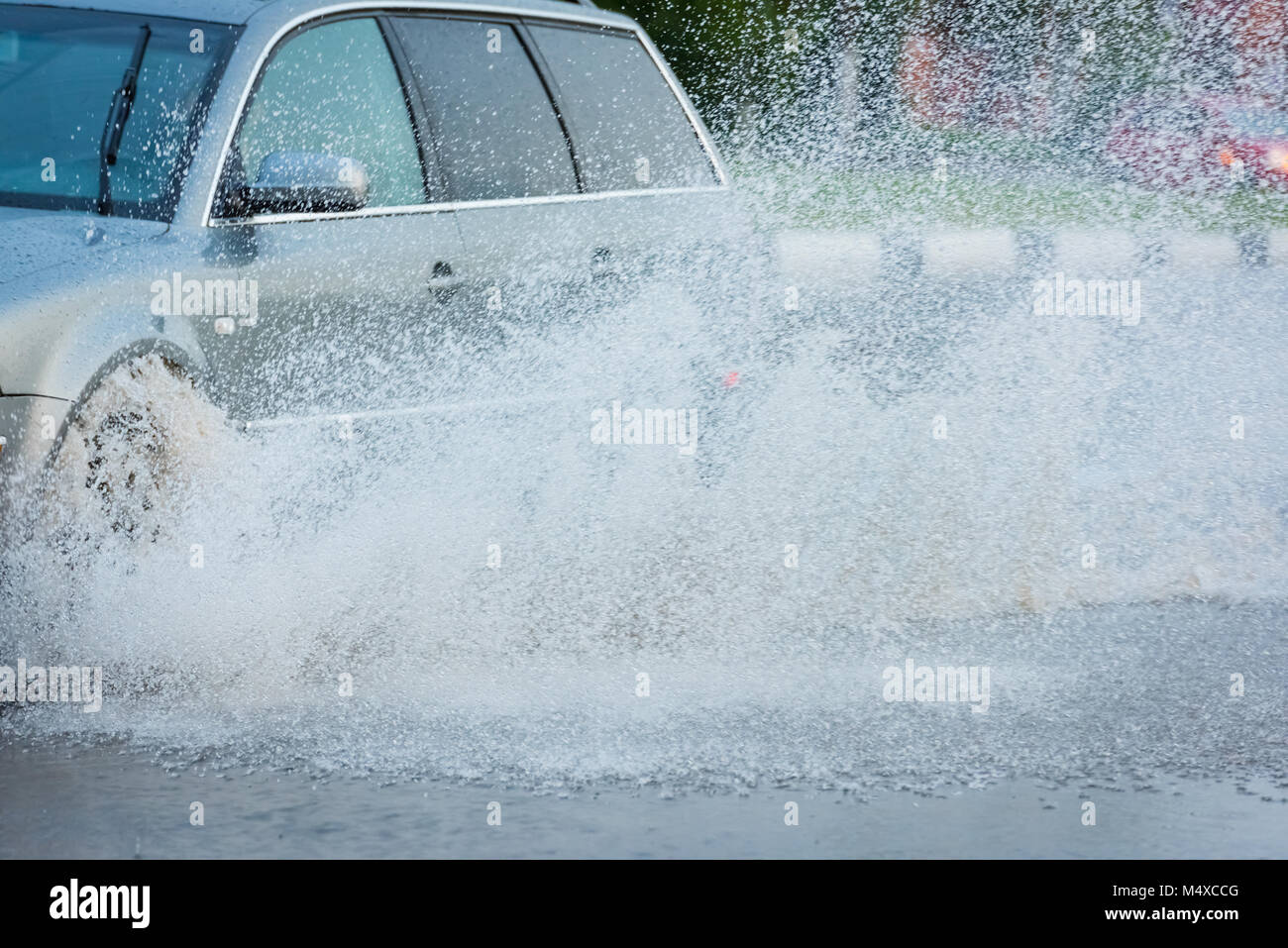car rain puddle splashing water Stock Photo - Alamy