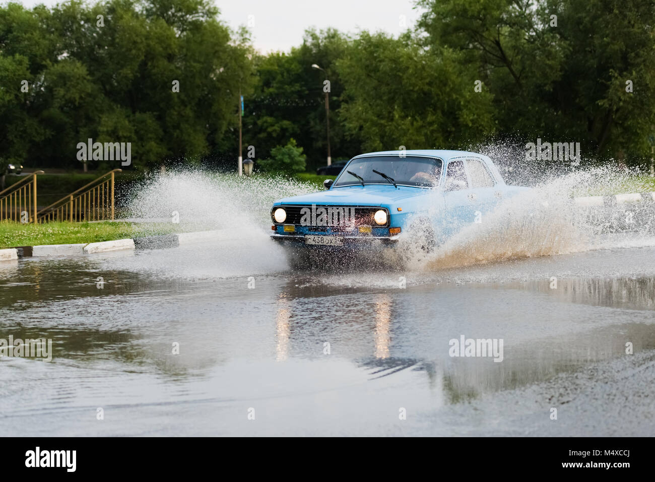 car rain puddle splashing water Stock Photo - Alamy