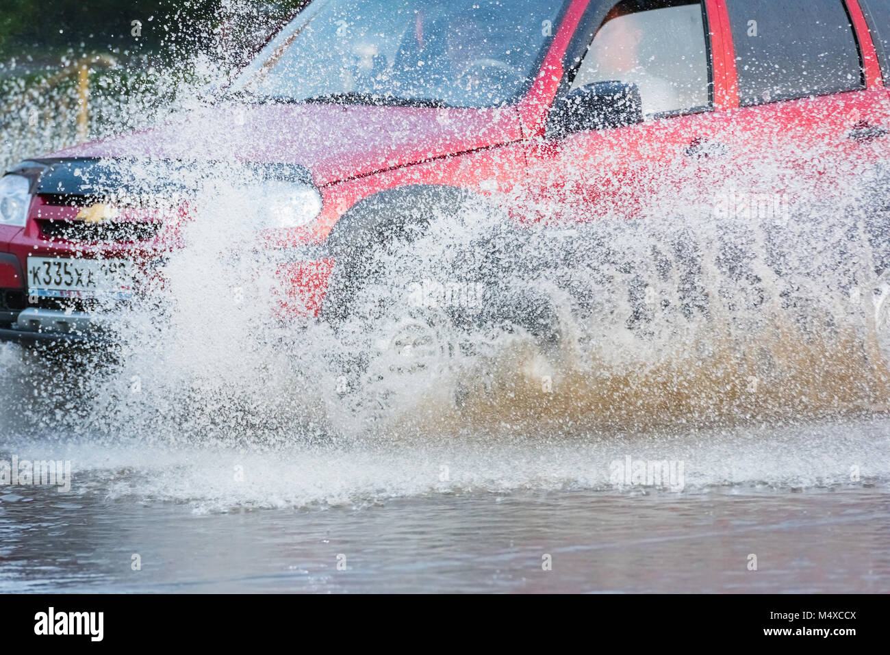 car rain puddle splashing water Stock Photo - Alamy