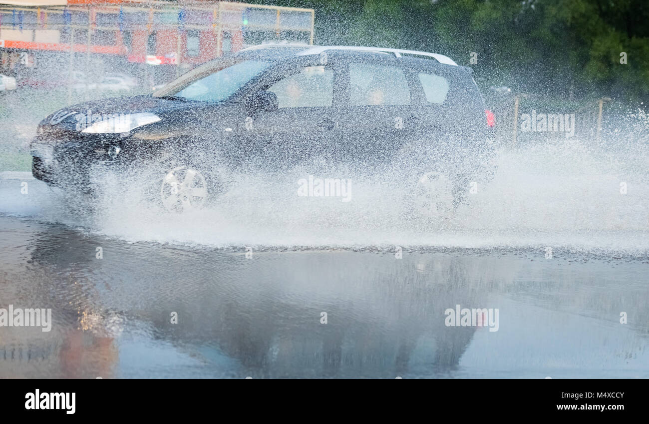 car rain puddle splashing water Stock Photo - Alamy