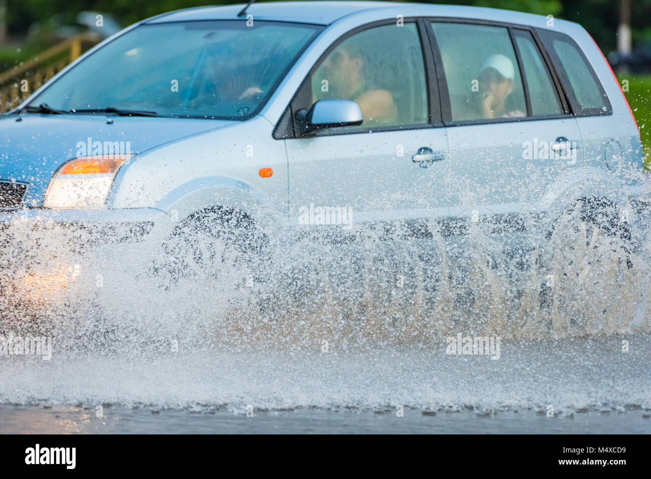 car rain puddle splashing water Stock Photo - Alamy