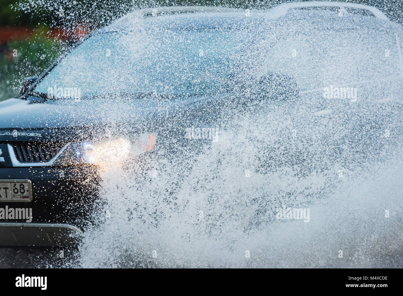 car rain puddle splashing water Stock Photo - Alamy
