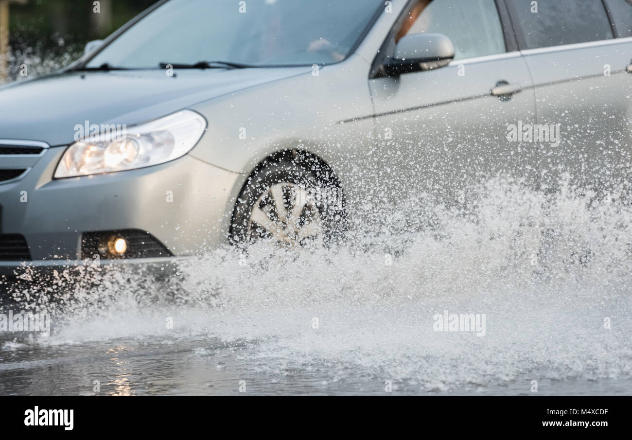 car rain puddle splashing water Stock Photo - Alamy