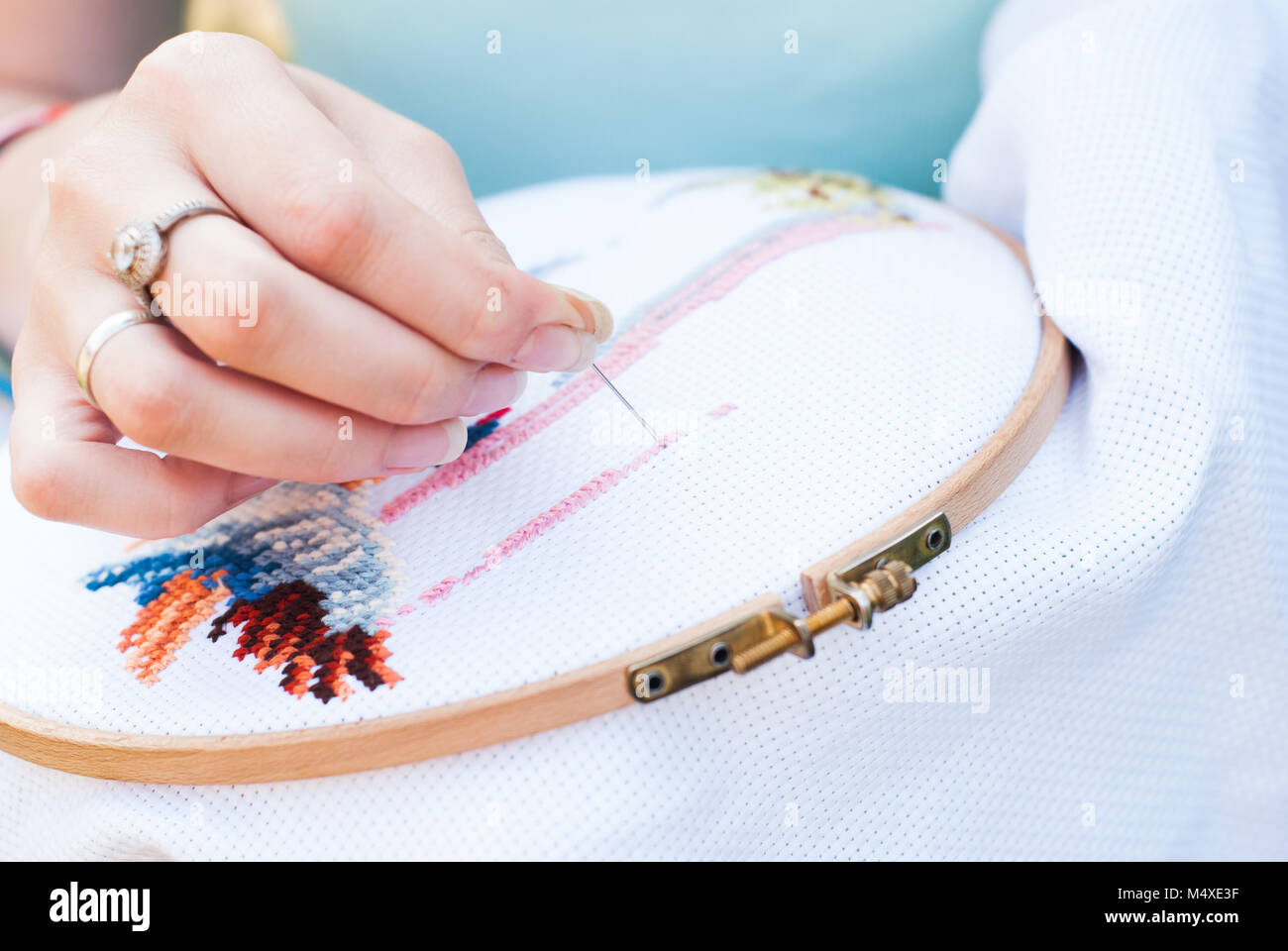 Female hand embroiders angels in the hoop, Young girl embroiders a ...