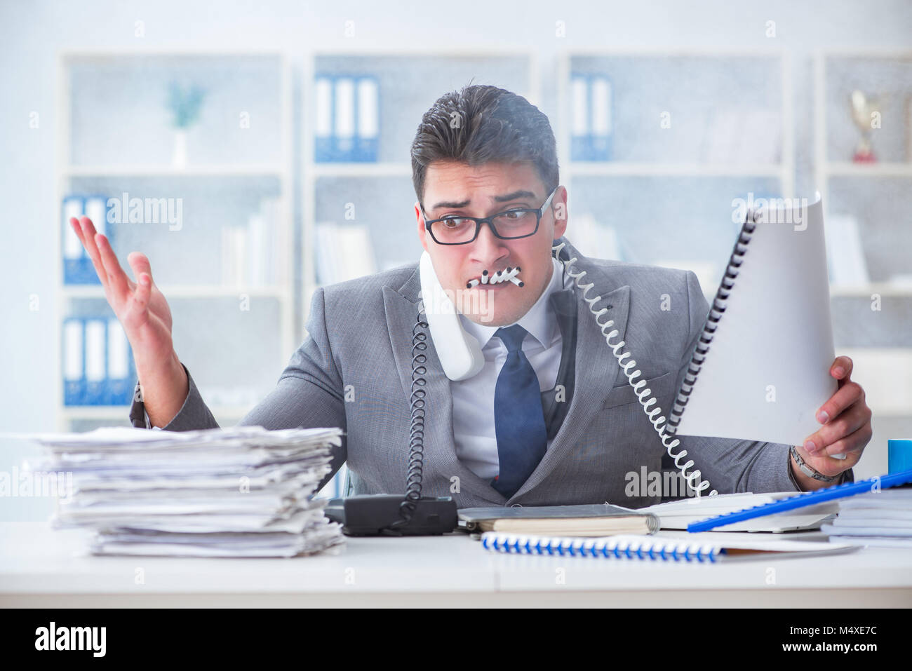 Businessman smoking in office at work Stock Photo - Alamy