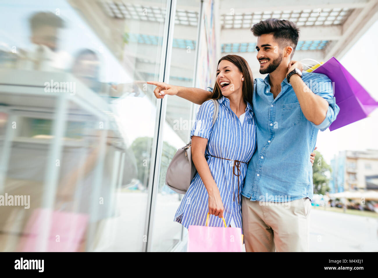 Happy attractive loving couple enjoy shopping together Stock Photo - Alamy