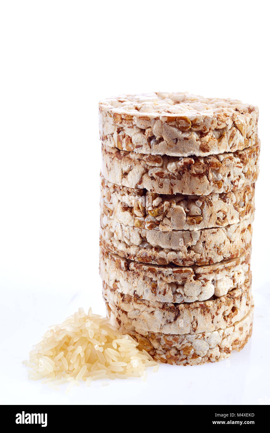 Round wheat crispbread, white background. Composition of grain ...