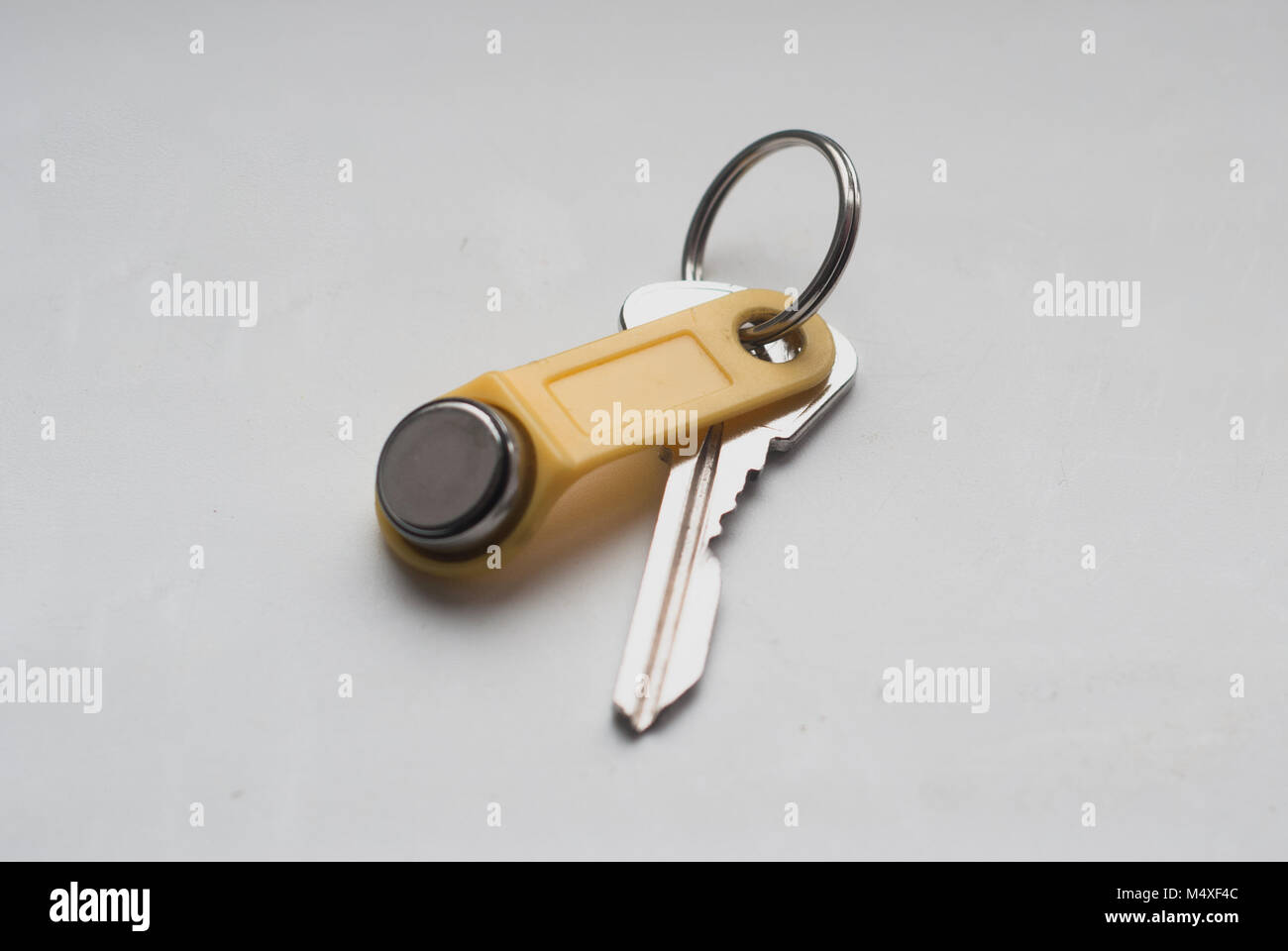 The keys to the apartment and intercom, yellow keychain Stock Photo - Alamy