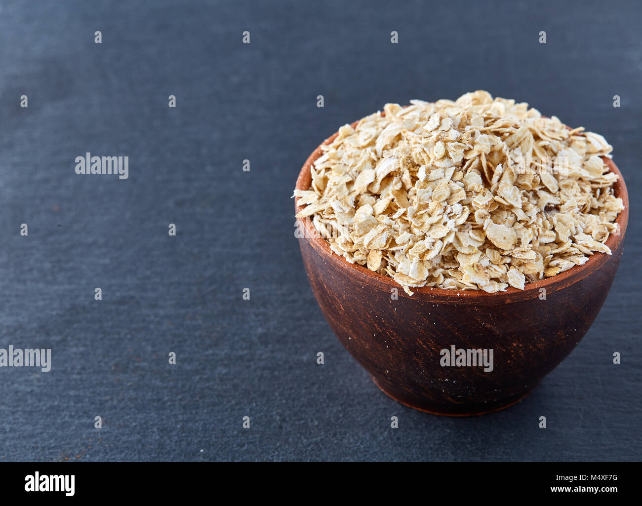 Top view of a yellow oats pyramid positioned in the corner on a black ...