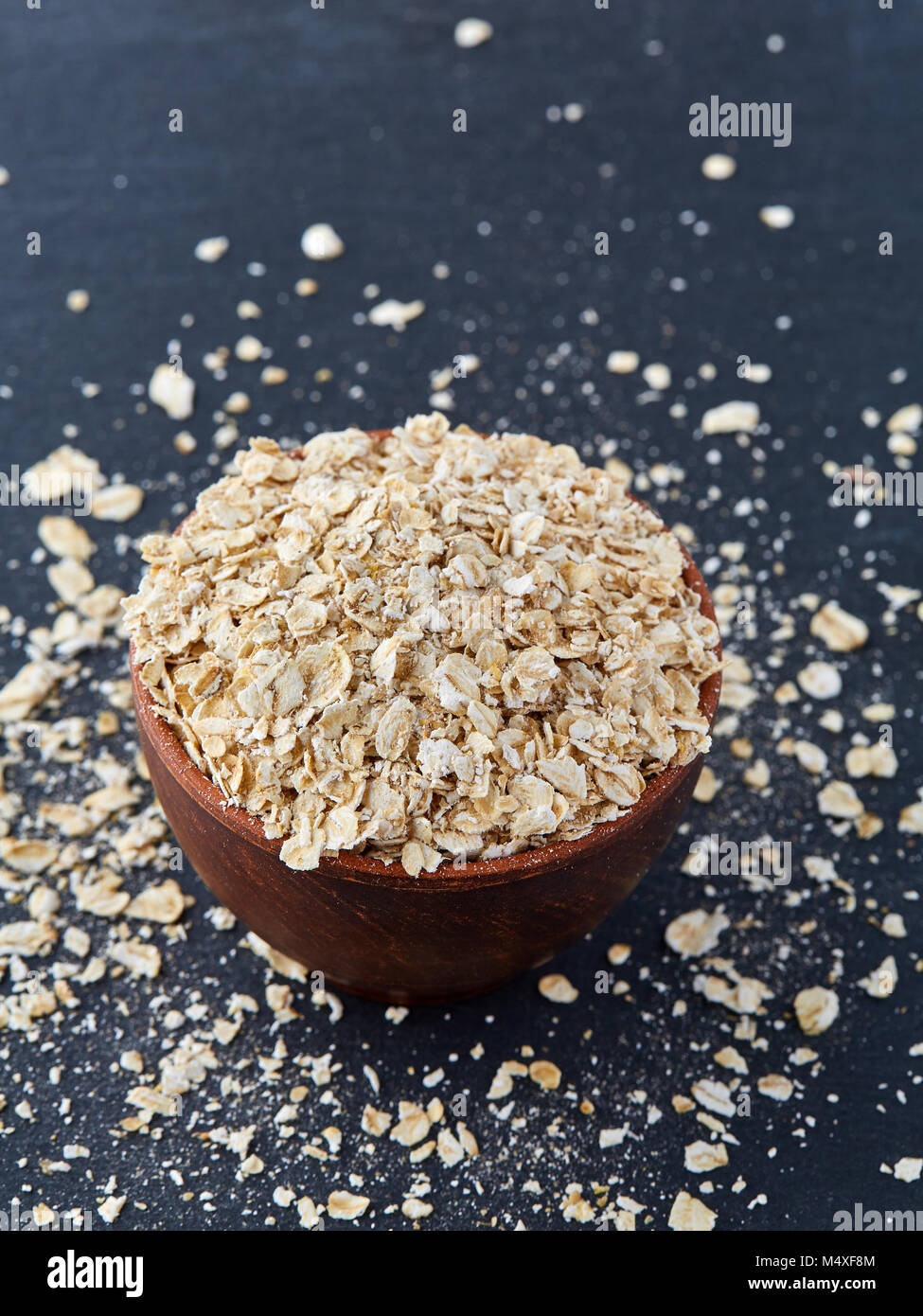 Top view of a yellow oats pyramid positioned in the corner on a black ...