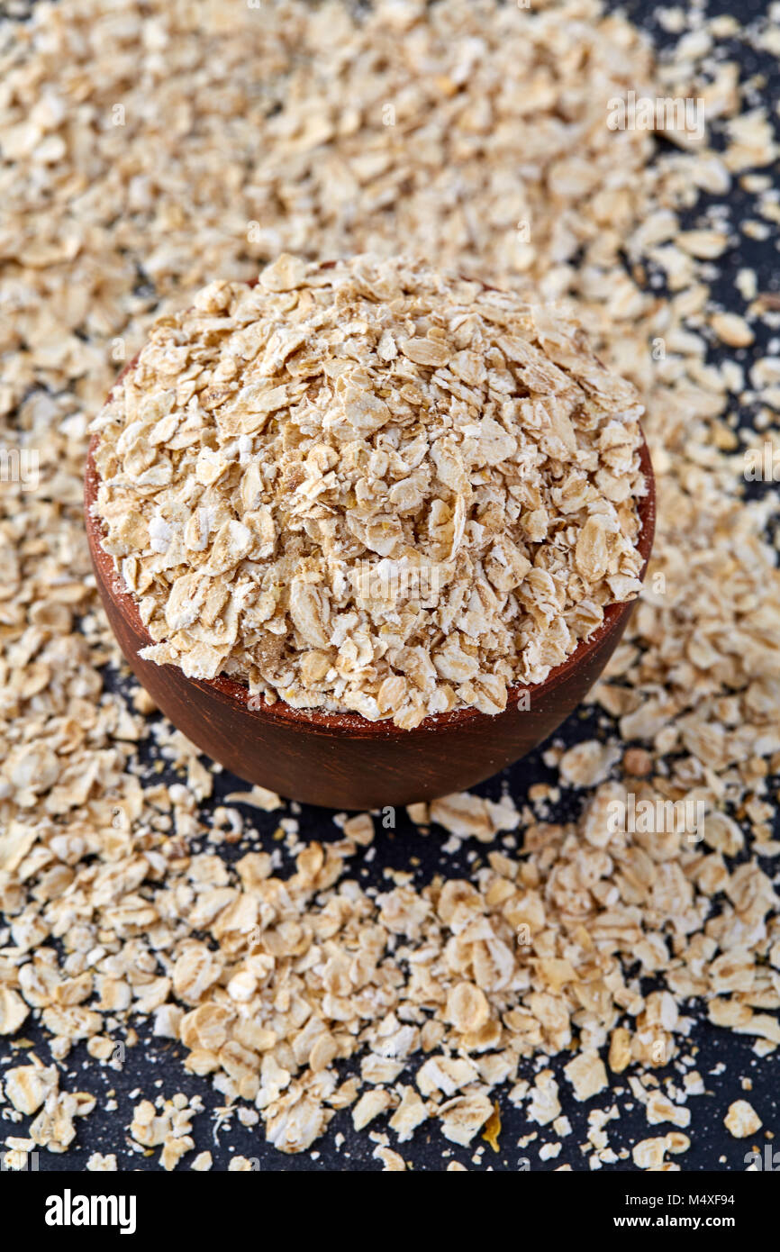 Top view of a yellow oats pyramid positioned in the corner on a black ...