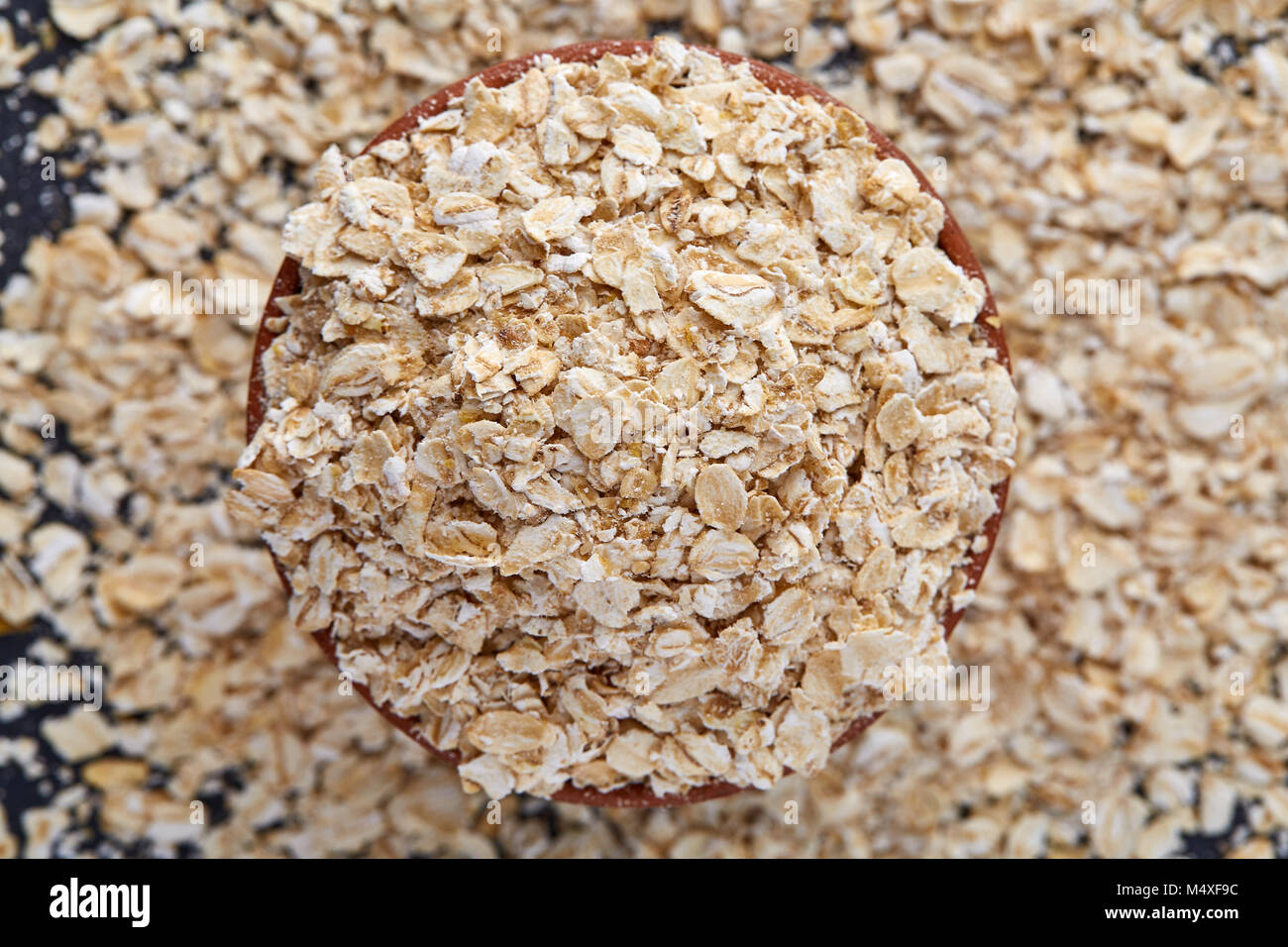 Top view of a yellow oats pyramid positioned in the corner on a black ...