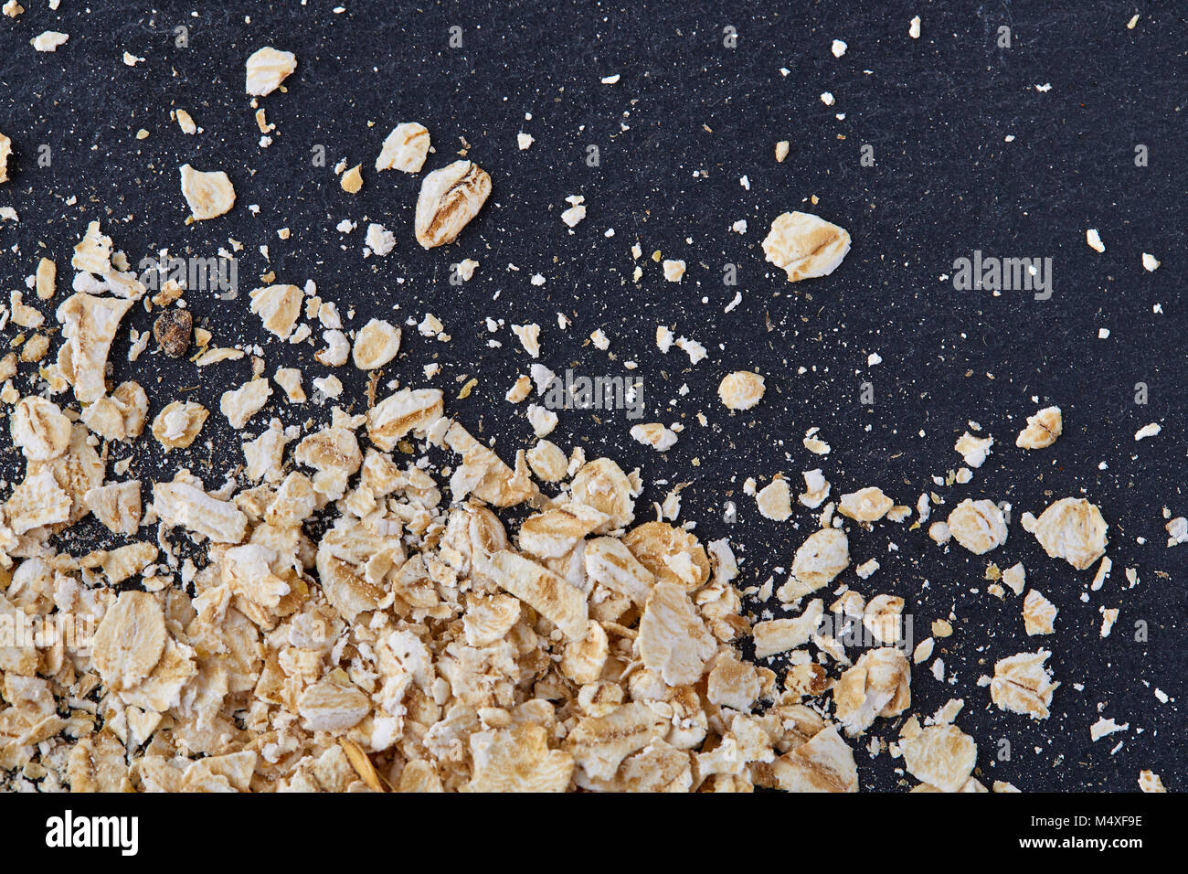 Top view of a yellow oats pyramid positioned in the corner on a black ...
