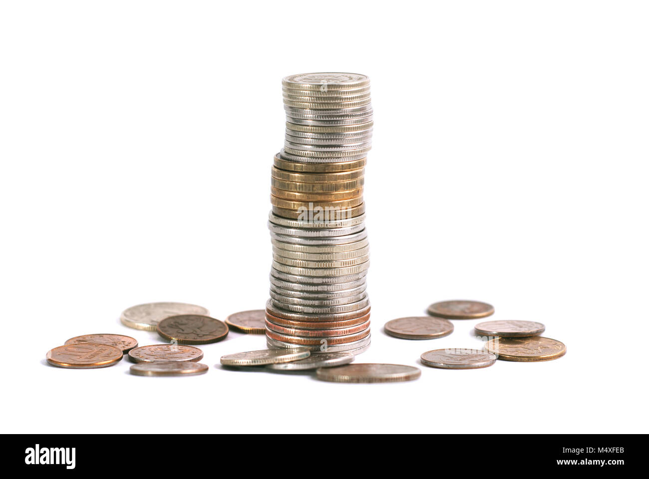 stack of coins isolated on a white background with scattered coins ...