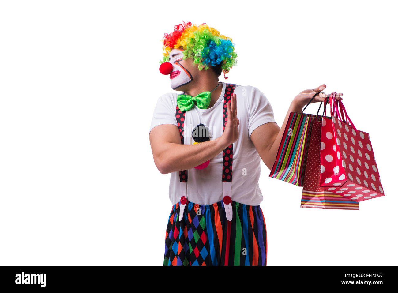 Funny clown after shopping bags isolated on white background Stock ...