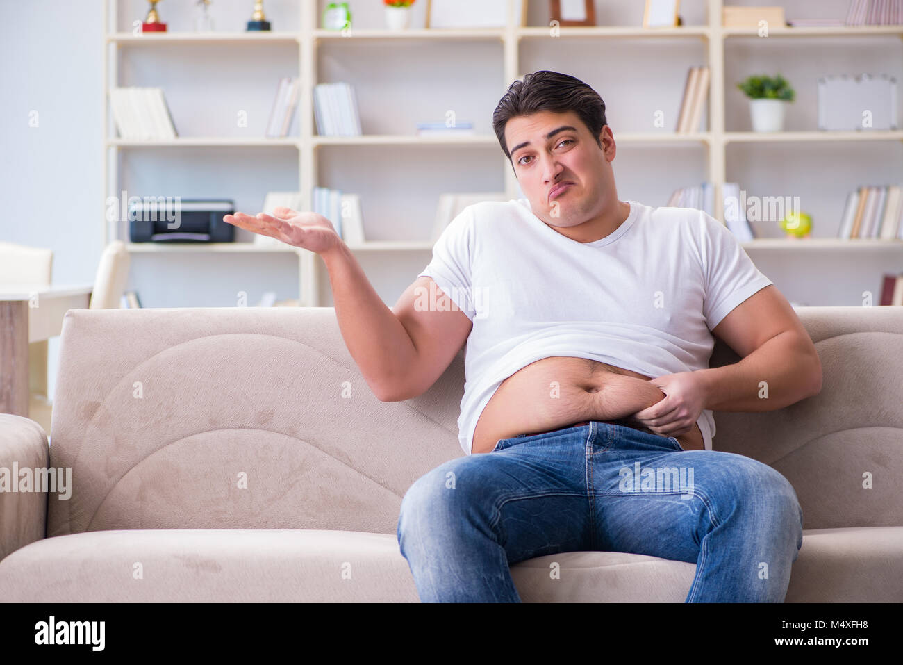 Man suffering from extra weight in diet concept Stock Photo - Alamy
