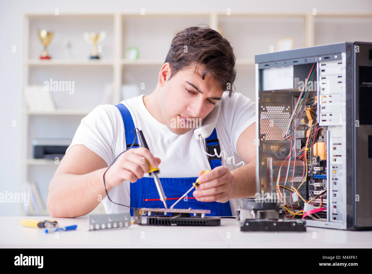Computer repairman repairing desktop computer Stock Photo - Alamy