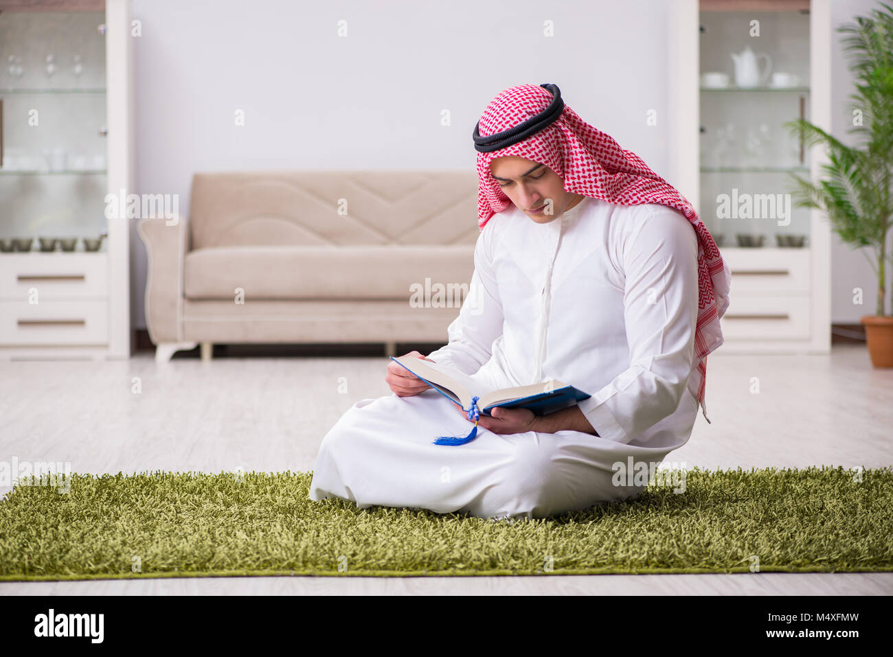 Arab man praying at home Stock Photo - Alamy