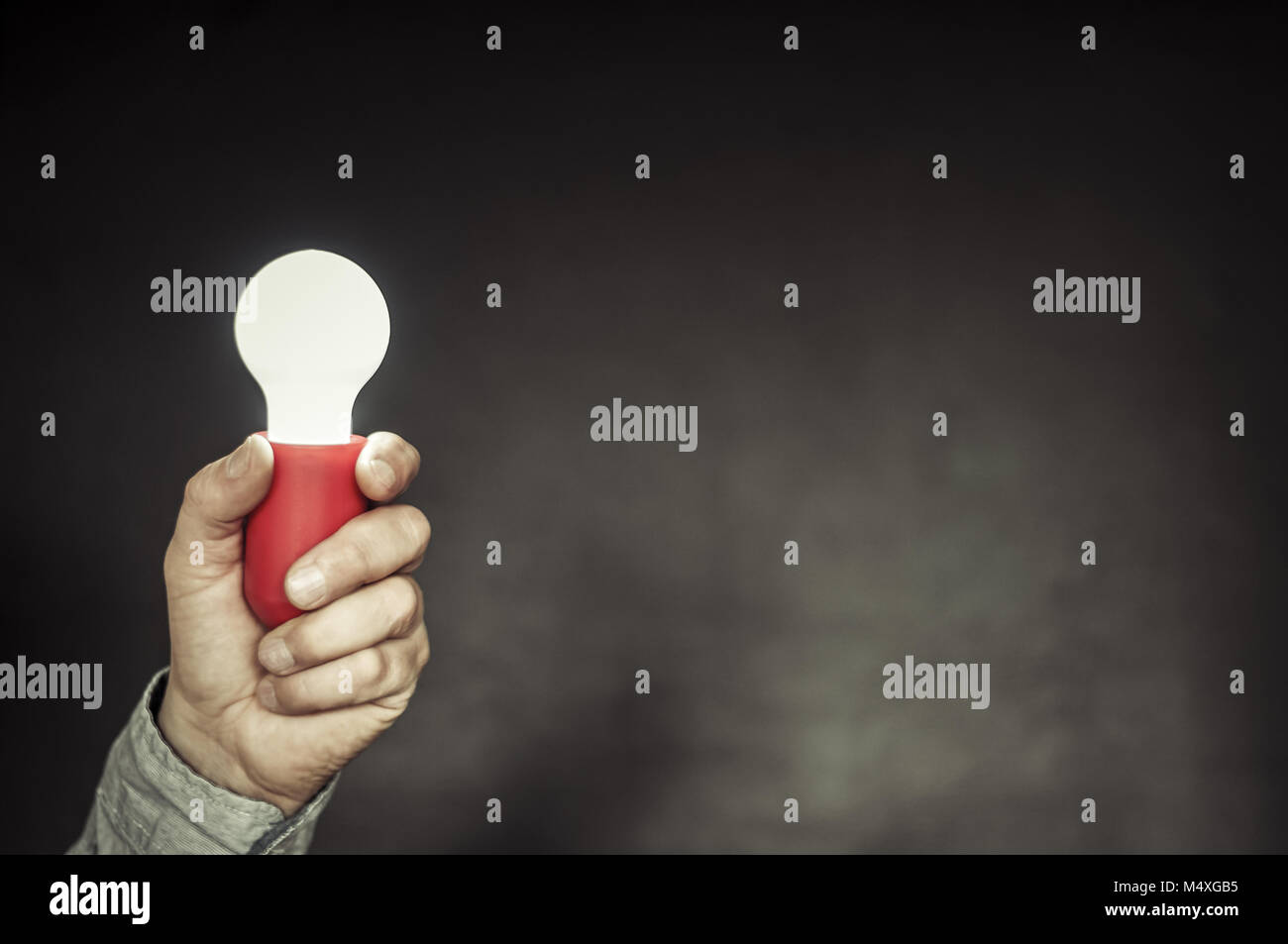 Black hand holding light bulb hi-res stock photography and images - Alamy