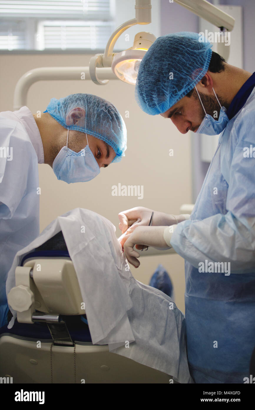 Surgeons in surgery room makes medical operation for patient Stock ...