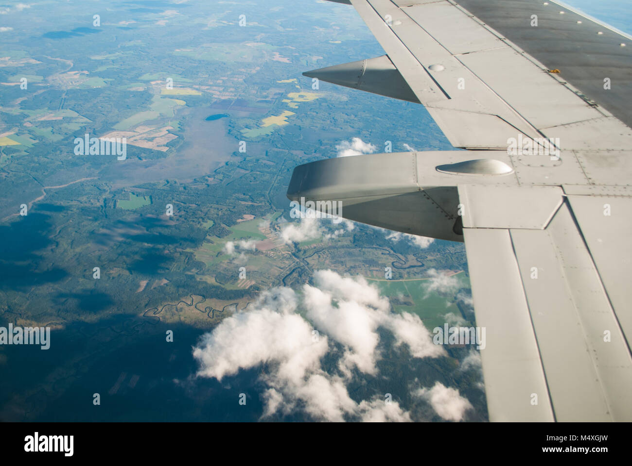 Fields and forests under the wing of the aircraft, the view from the ...