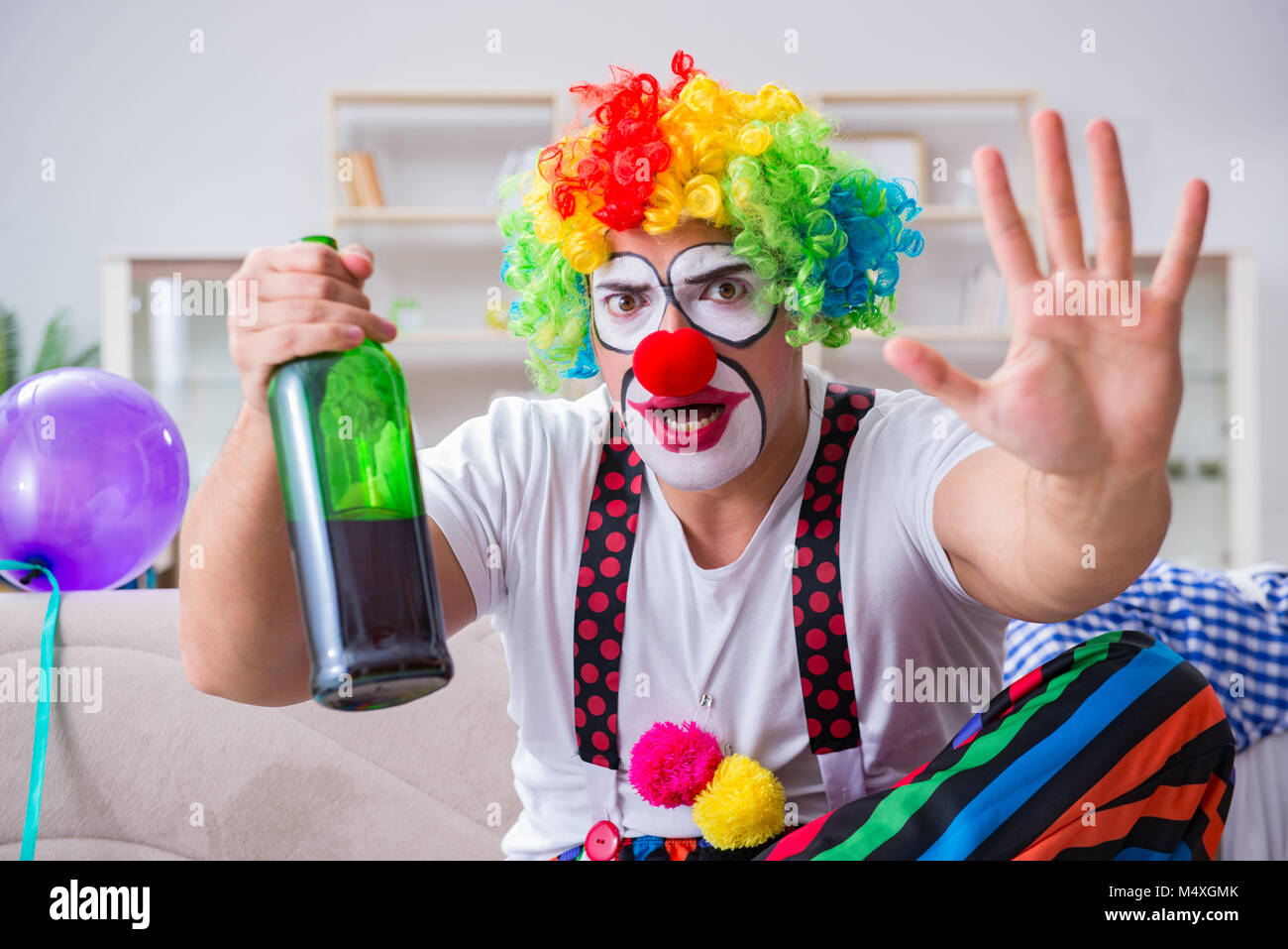 Drunk clown celebrating having a party at home Stock Photo - Alamy