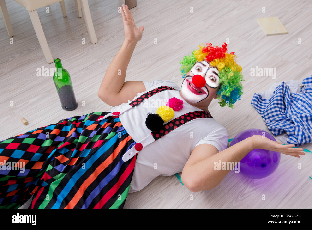 Drunk clown celebrating having a party at home Stock Photo - Alamy