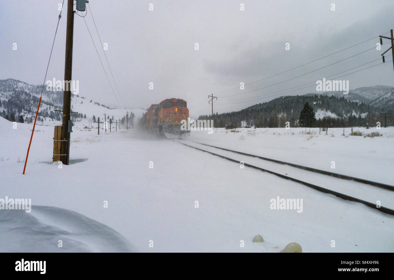 A BNSF train coming down the tracks in the snow at Beavertail, west of ...