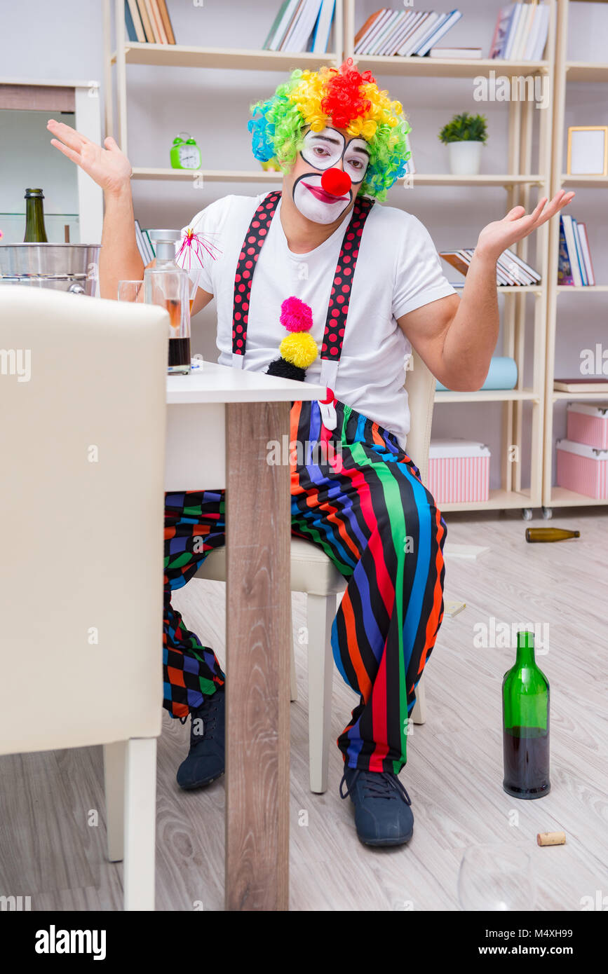 Drunk clown celebrating having a party at home Stock Photo - Alamy
