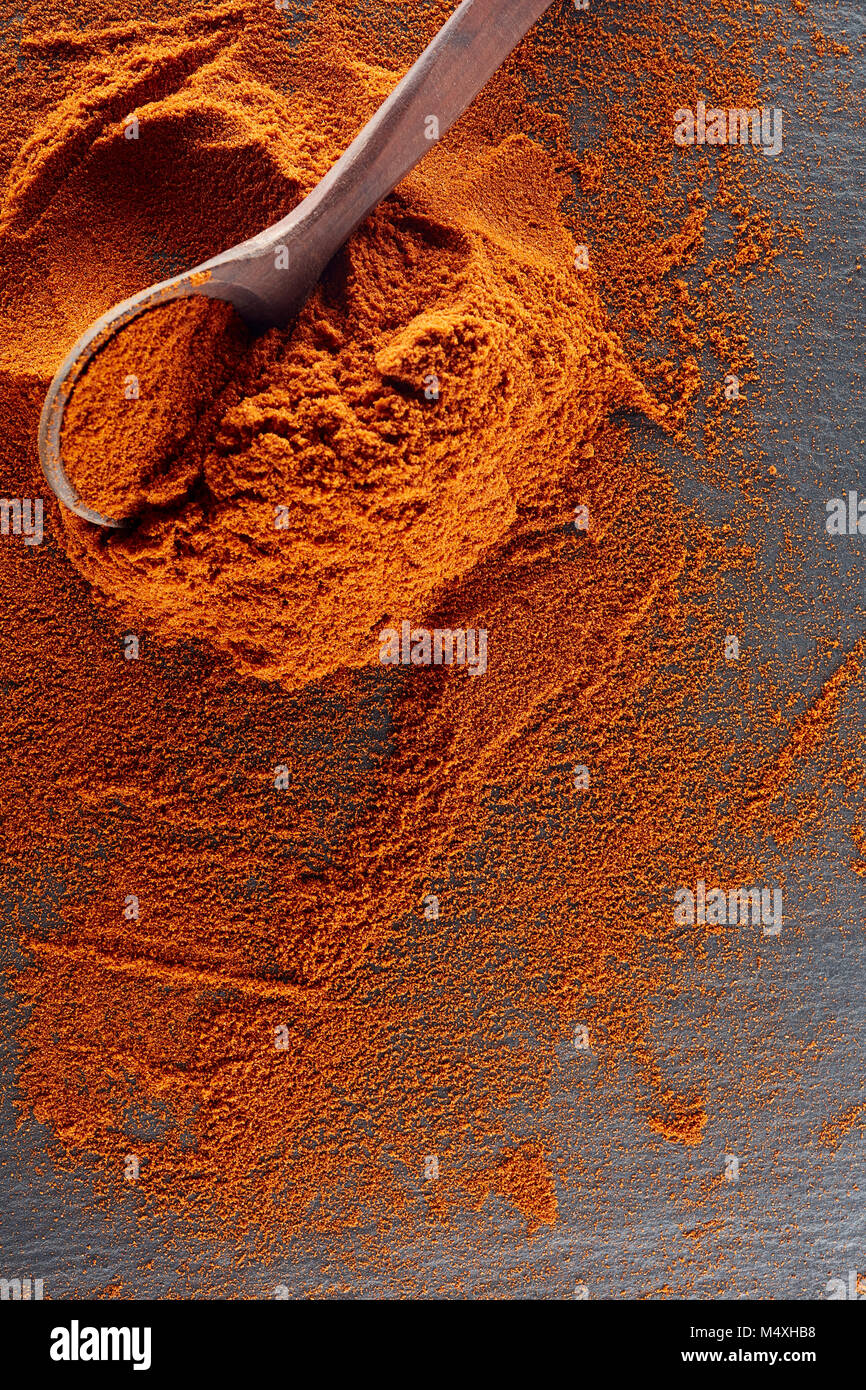 Top view on the texture background of red chilli pepper powder mixed ...