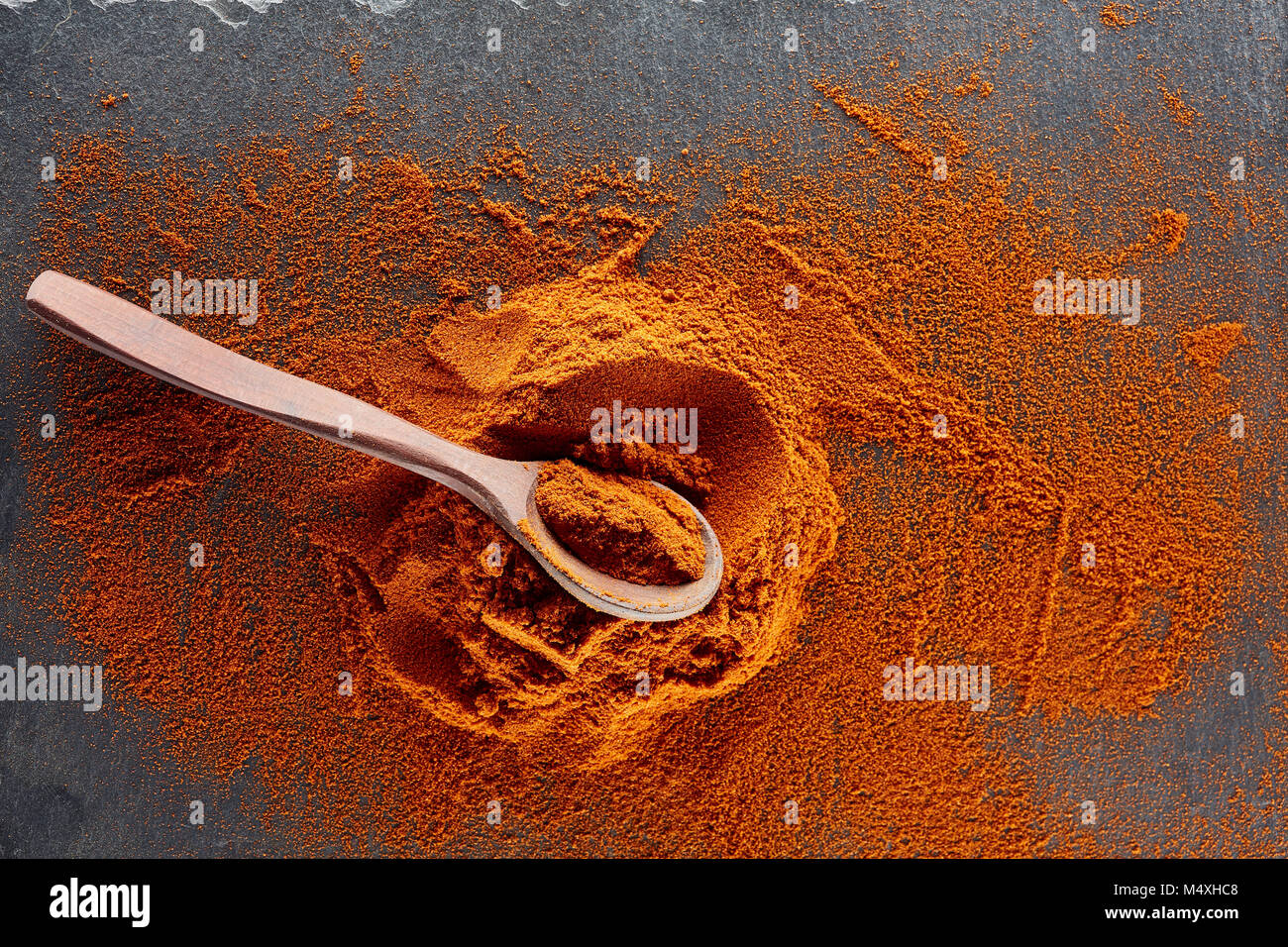 Top view on the texture background of red chilli pepper powder mixed ...