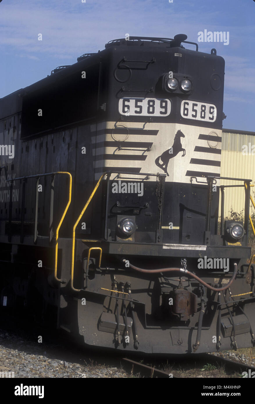 A black and white Norfolk Southern Railway locomotive, in a rail yard ...