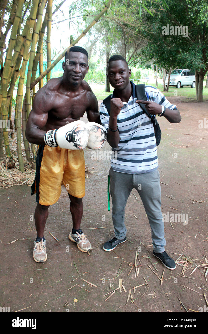 Ugandan renowned kick-boxer Moses Golola poses with a fan during ...