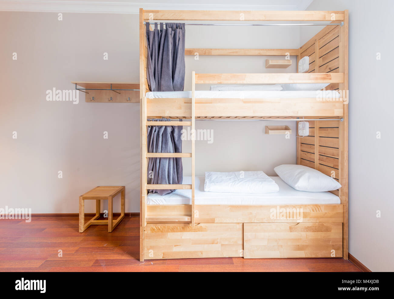 Hostel dormitory beds arranged in room Stock Photo - Alamy