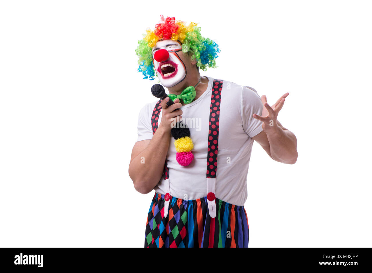 Funny clown with a microphone singing karaoke isolated on white Stock ...