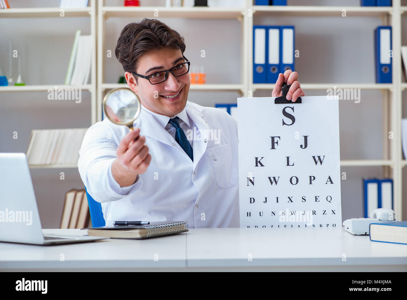 Doctor optician with letter chart conducting an eye test check Stock ...