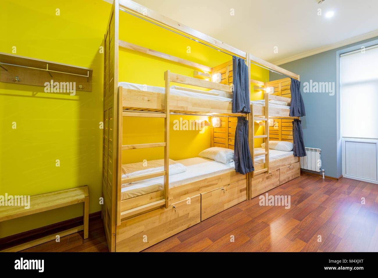 Hostel dormitory beds arranged in room Stock Photo - Alamy