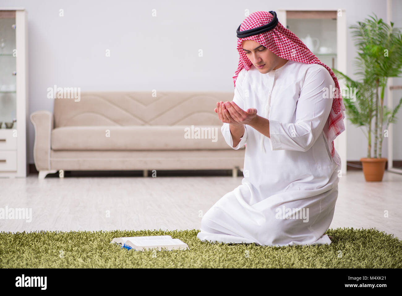 Arab man praying at home Stock Photo - Alamy