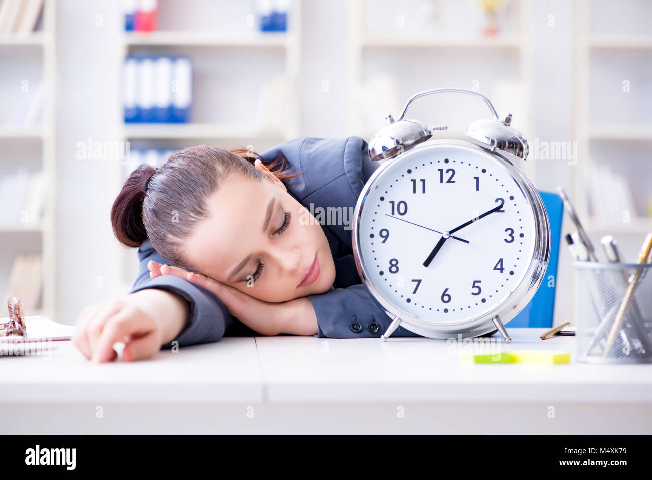 Businesswoman in time management concept sleeping Stock Photo - Alamy