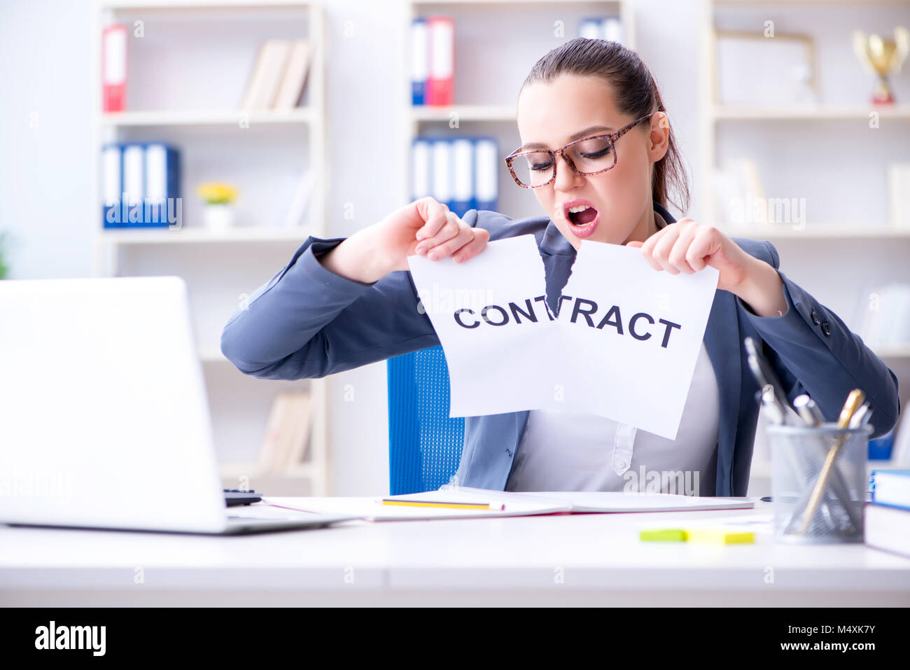 Businesswoman tearing apart her contract Stock Photo - Alamy