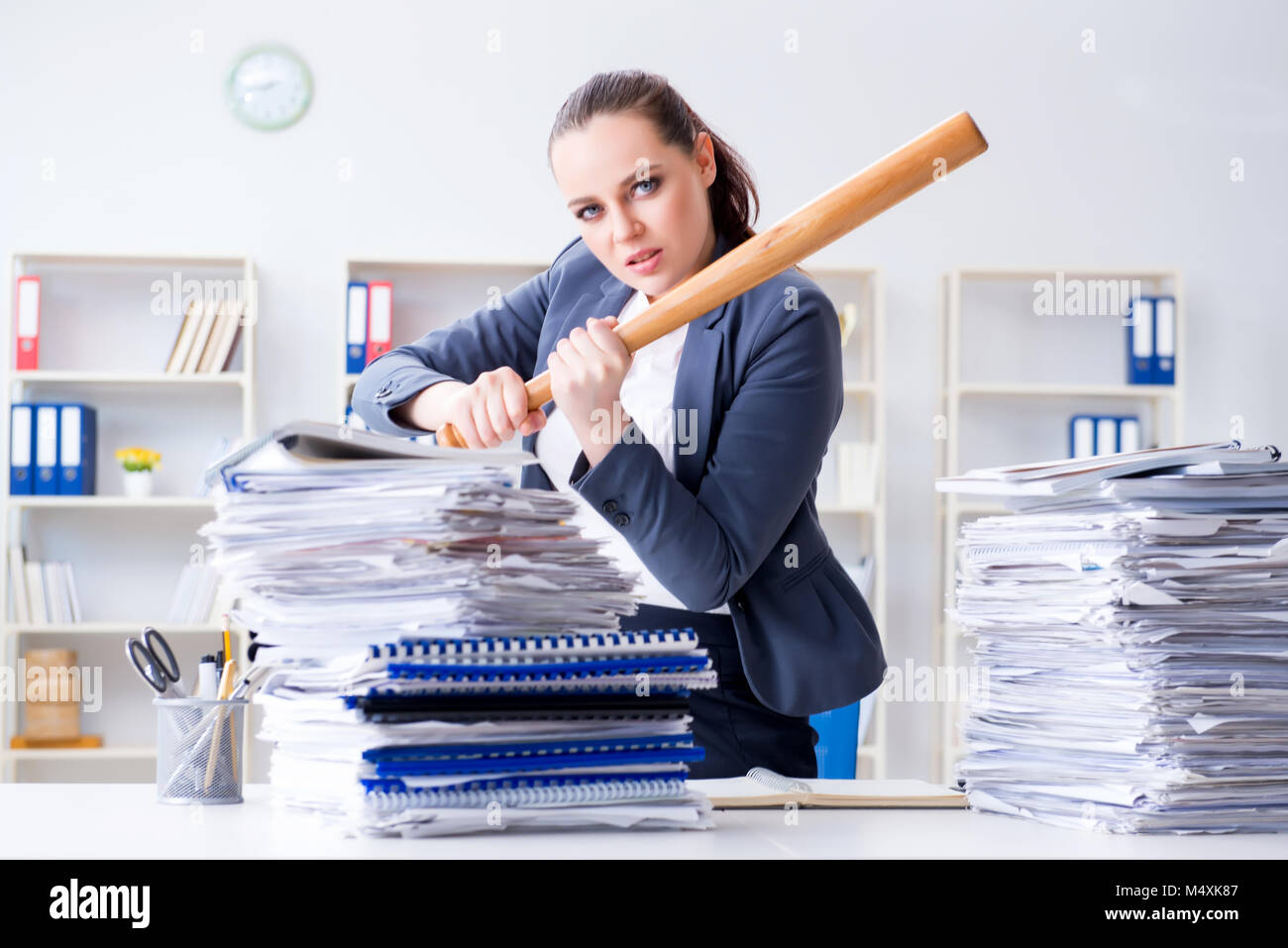 Angry businesswoman with baseball bat in office Stock Photo - Alamy